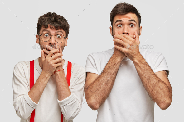 People and teamwork concept. Frightened two young men cover mouthes ...