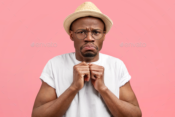 Negative facial expressions. Serious dark skinned male has offended ...