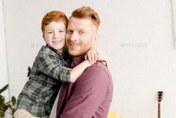 happy redhead father and son hugging and smiling at camera Stock Photo ...