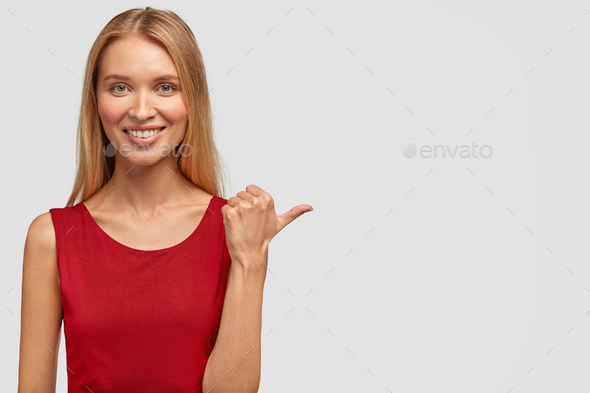 Horizontal shot of pretty happy slim woman has gentle smile, appealing ...