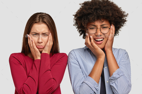 Dejected sad two diverse women have miserable expressions, cry ...