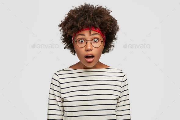 Stupefied surprised dark skinned African American woman keeps jaw ...