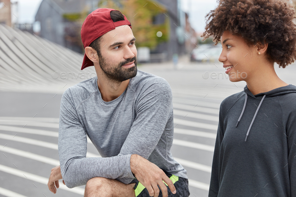 Horizontal shot of multiethnic best friends, groupmates spend free time ...
