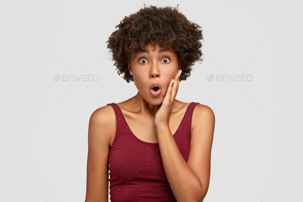 Photo of astonished ethnic woman with bugged eyes, keeps mouth opened ...