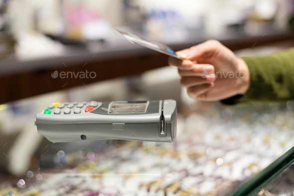 Woman using mobile phone for paying the bill Stock Photo by leungchopan