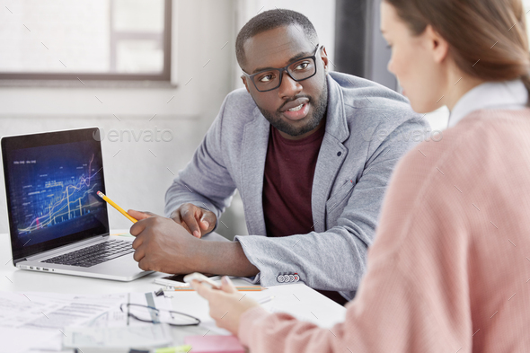 Business and analyzing concept. Black man and his female colleague work ...