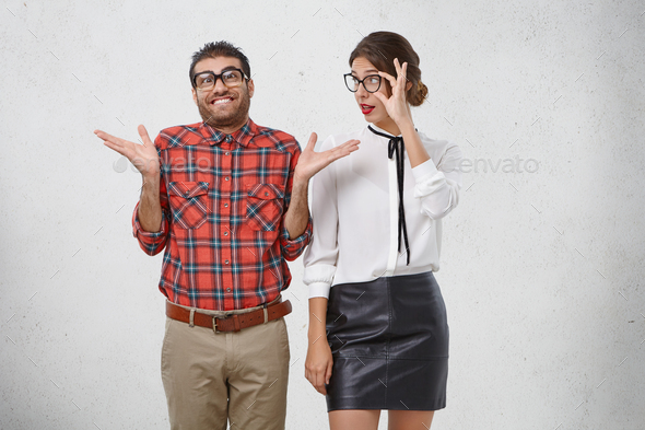 Clueless clumsy man wears checkered shirt and spectacles with thick ...