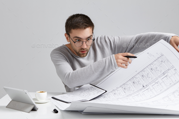 Isolated picture of shocked terrified young student engineer wearing ...