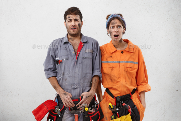 Picture of sad disappointed young male and female plumbers wearing ...