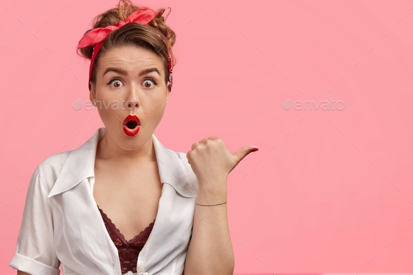 Portrait of good looking stunned young female model has astonished ...