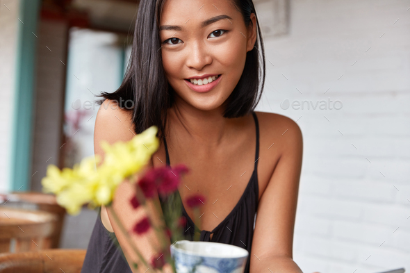 Candid Shot Of Beautiful Japanese Woman With Pleasant Smile Spends