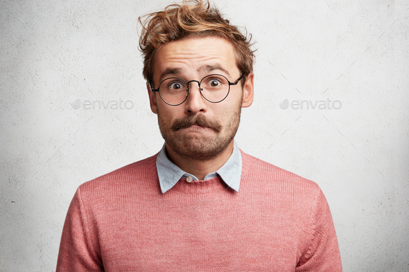 Photo of clueless handsome attractive young male looks with shocked ...