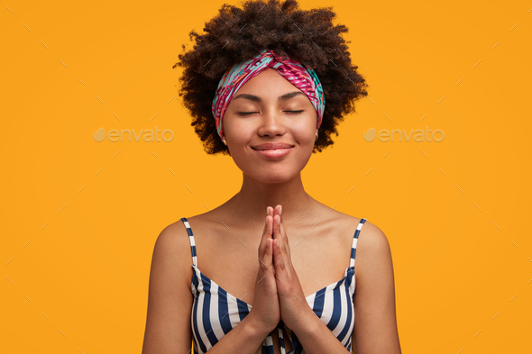 Pleasant looking delighted female with pleased expression, gentle smile ...