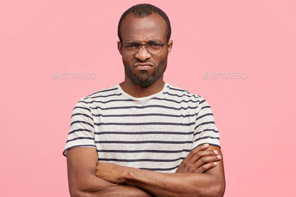 Horizontal shot of discontent African American male model with ...