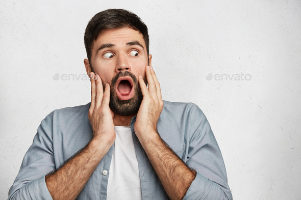 Scared emotional surprised male model notices his phobia aside ...