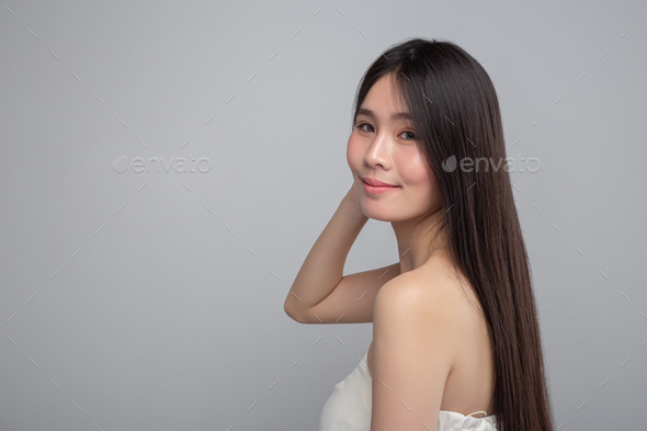 That woman wore a white strapless dress and her hands touch her hair ...