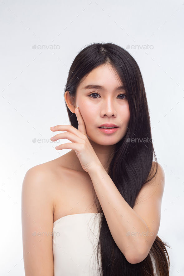 The woman wore a white strapless dress and hands touch her face. Stock ...