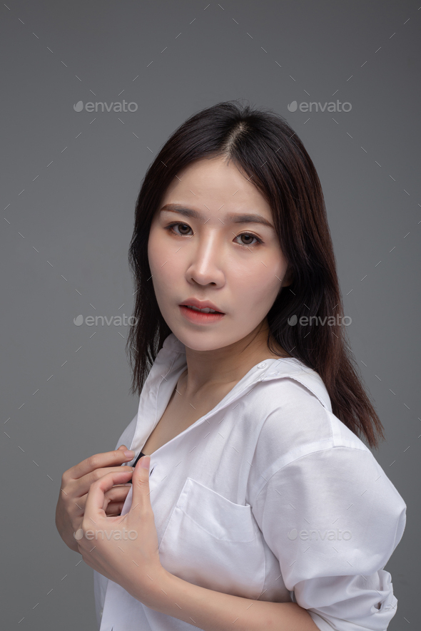 The woman is wearing a white shirt and facing the left hand side. Stock ...