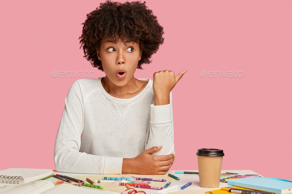 Indoor shot of surprised shocked woman has stupefied facial expression ...