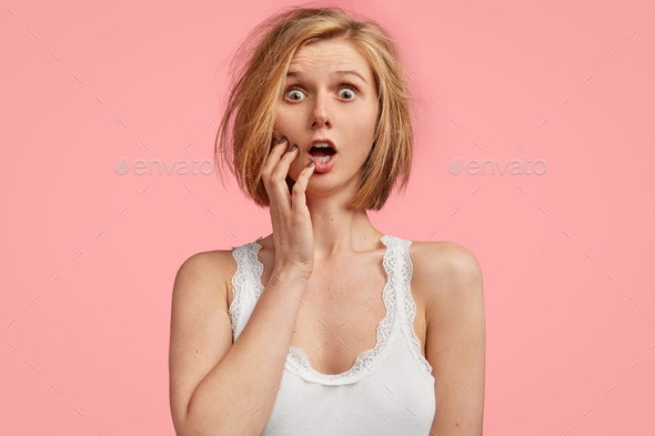 Portrait of stunned Caucasian female with sleepy look, faces some ...