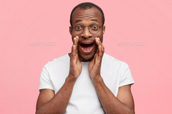 Happy African American male exclaims with overjoyed expression ...