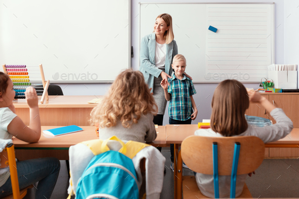 Young happy teacher introduces the new student to the class Stock Photo ...