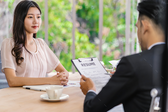 Young Asian woman graduate interviewing with two manager with positive ...