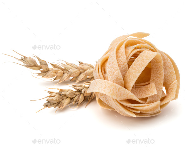 Italian pasta fettuccine nest and wheat ears still life isolated on ...
