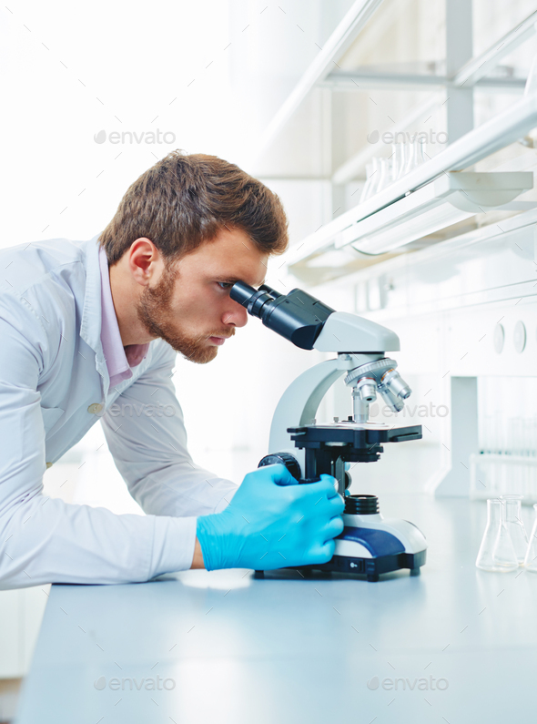 Using microscope Stock Photo by Pressmaster | PhotoDune