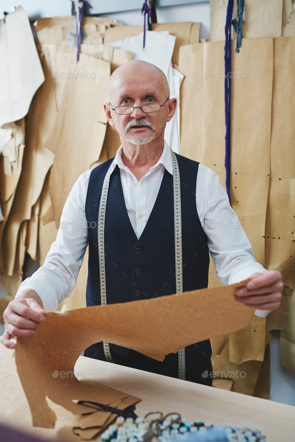 Tailor with paper pattern Stock Photo by Pressmaster | PhotoDune