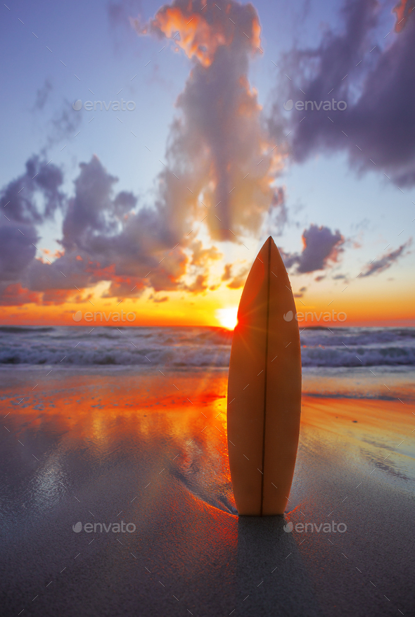surfboard on the beach in sea shore at sunset time Stock Photo by Netfalls