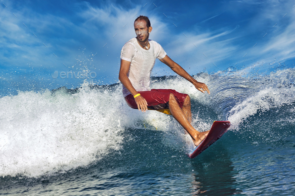 Male surfer on a blue wave at sunny day Stock Photo by trubavin | PhotoDune