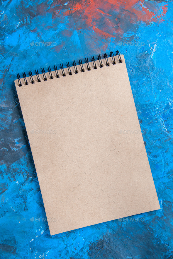 top view a notepad on blue background Stock Photo by AydinovKamran