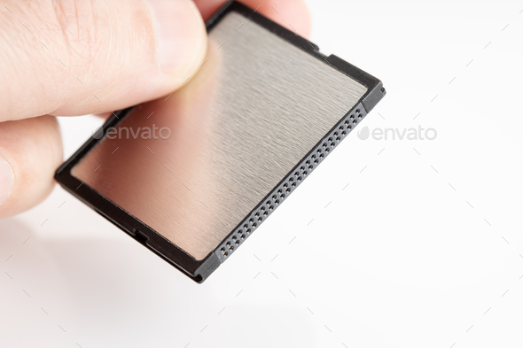 Hand holding a Compactflash memory card Stock Photo by fotodestock
