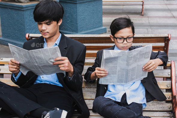Two Boys Reading Newspaper Stock Photo by Garakta-Studio | PhotoDune