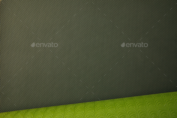 top view of green rolled yoga mat Stock Photo by LightFieldStudios