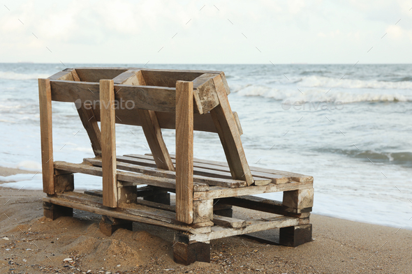 Wooden bench on beautiful sandy sea beach Stock Photo by AtlasComposer