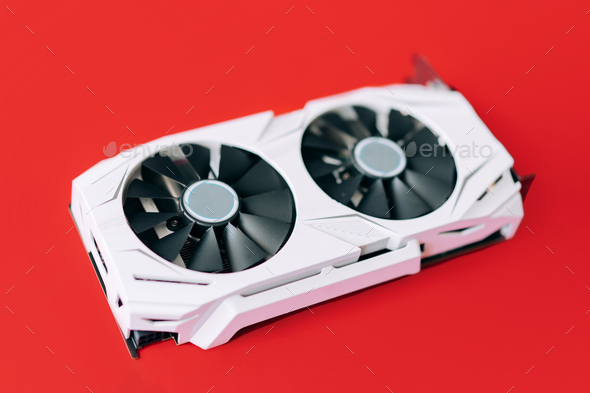 White graphics card with two black fans is located in the middle of red ...