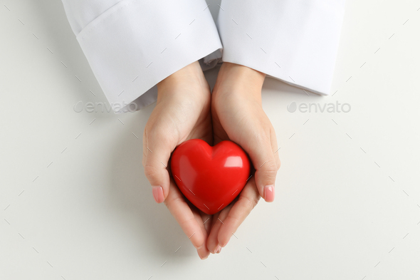 Female doctor hands holding heart on white background Stock Photo by ...