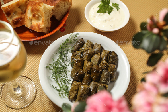 top view traditional azeri dish dolma in grape leaves with yoghurt and ...