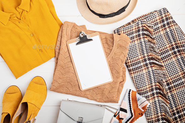 Second hand wardrobe idea. Top view over woman outfit Stock Photo by OksaLy