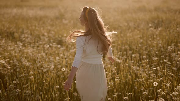 A Happy Woman is Running in Slow Motion Across Field with Camomiles at ...