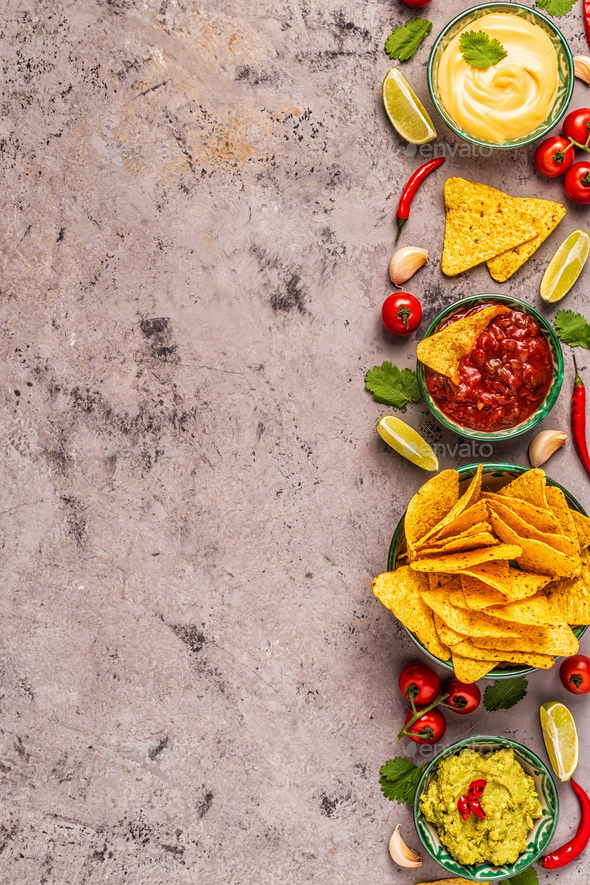 Mexican food background: guacamole, salsa, cheesy sauces with nachos ...
