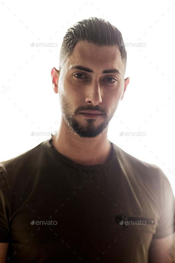 Handsome young man with a stylish hairstyle and stubble beard on Stock ...