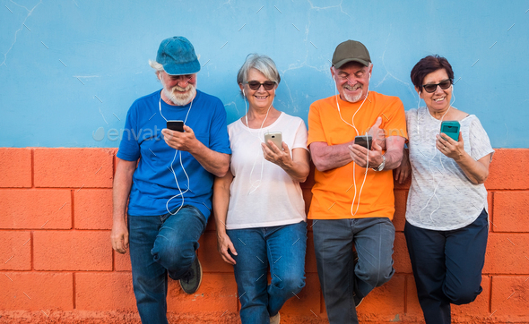 Two couples of brothers and wifes looking at smart phone smiling -happy ...