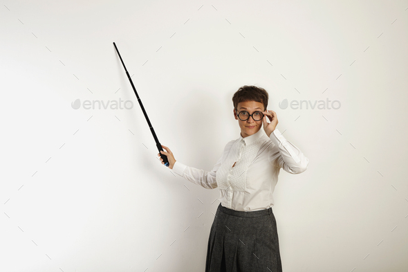 Female teacher with a pointer at white board Stock Photo by bublikhaus