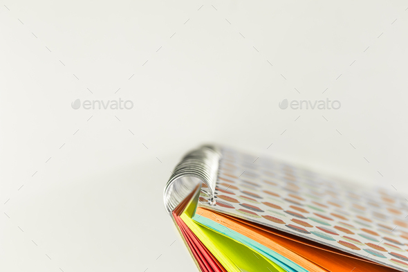 colored notebook with a spring on white background Stock Photo by puhimec