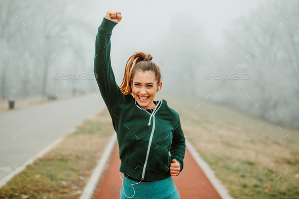 Beautiful female athlete with ponytail celebrating new personal best ...