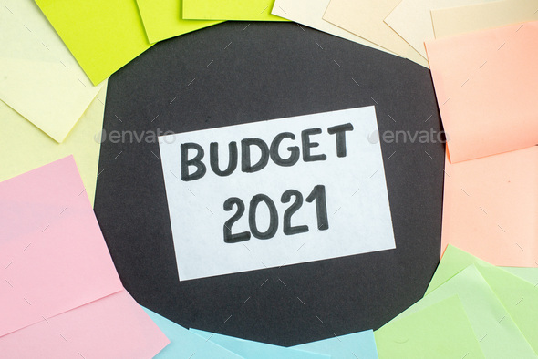 top view budget note around different colorful stickers on dark ...