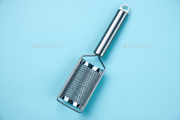 Top view of stainless kitchen tool lying on soft blue color background ...